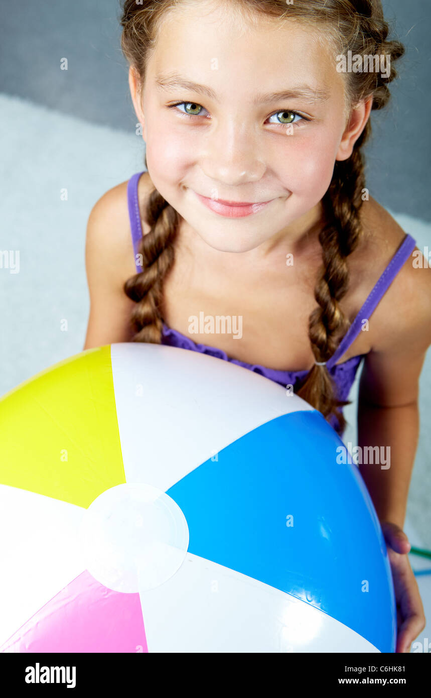 Portrait of young smiling child holding colorful ball Stock Photo - Alamy
