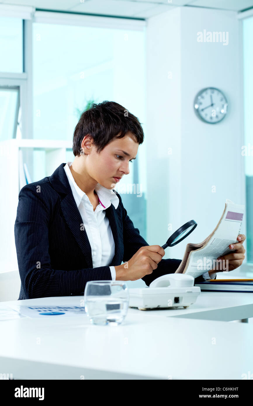 Photo of pretty businesswoman reading newspaper through spy glass Stock ...
