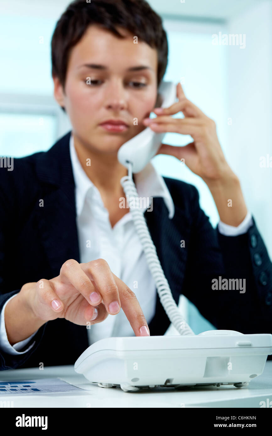 Photo of smart businesswoman pressing phone buttons in office Stock ...