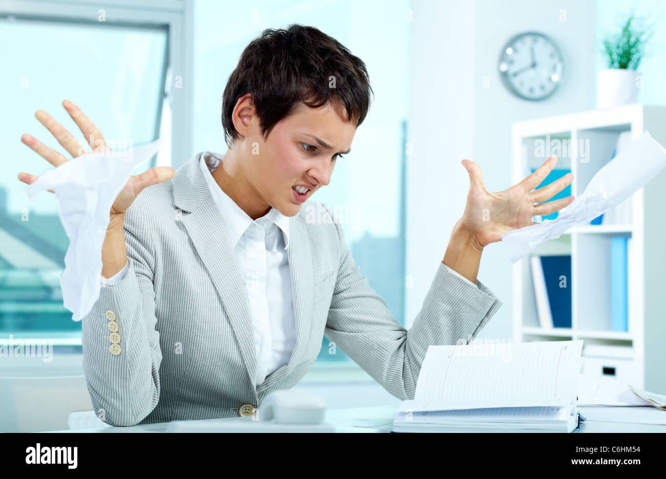 Image of young employer throwing papers with annoyed expression Stock ...