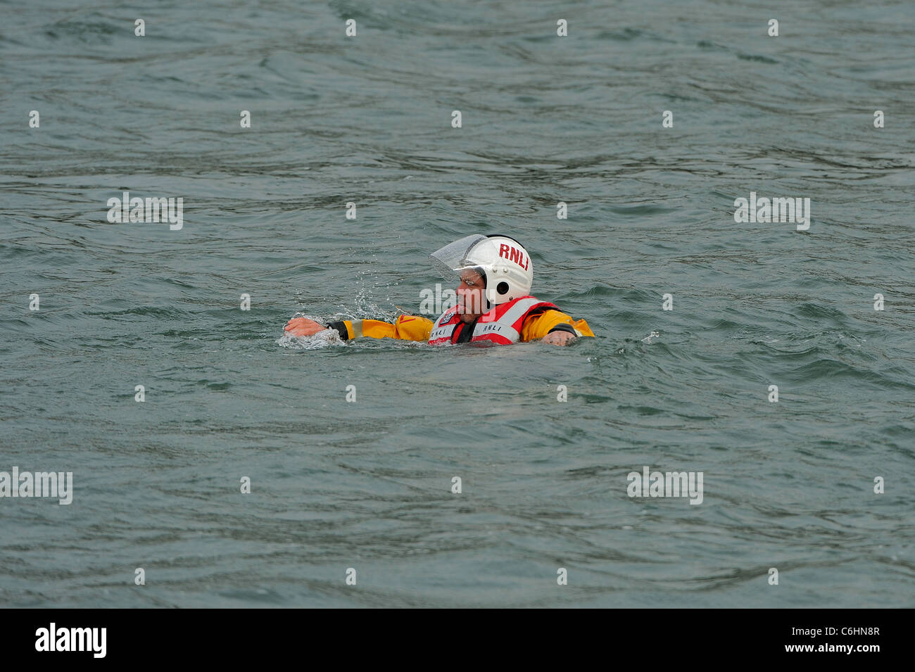 An RNLI Lifeboatman awaits rescue by a Royal Navy Sea King helicopter ...