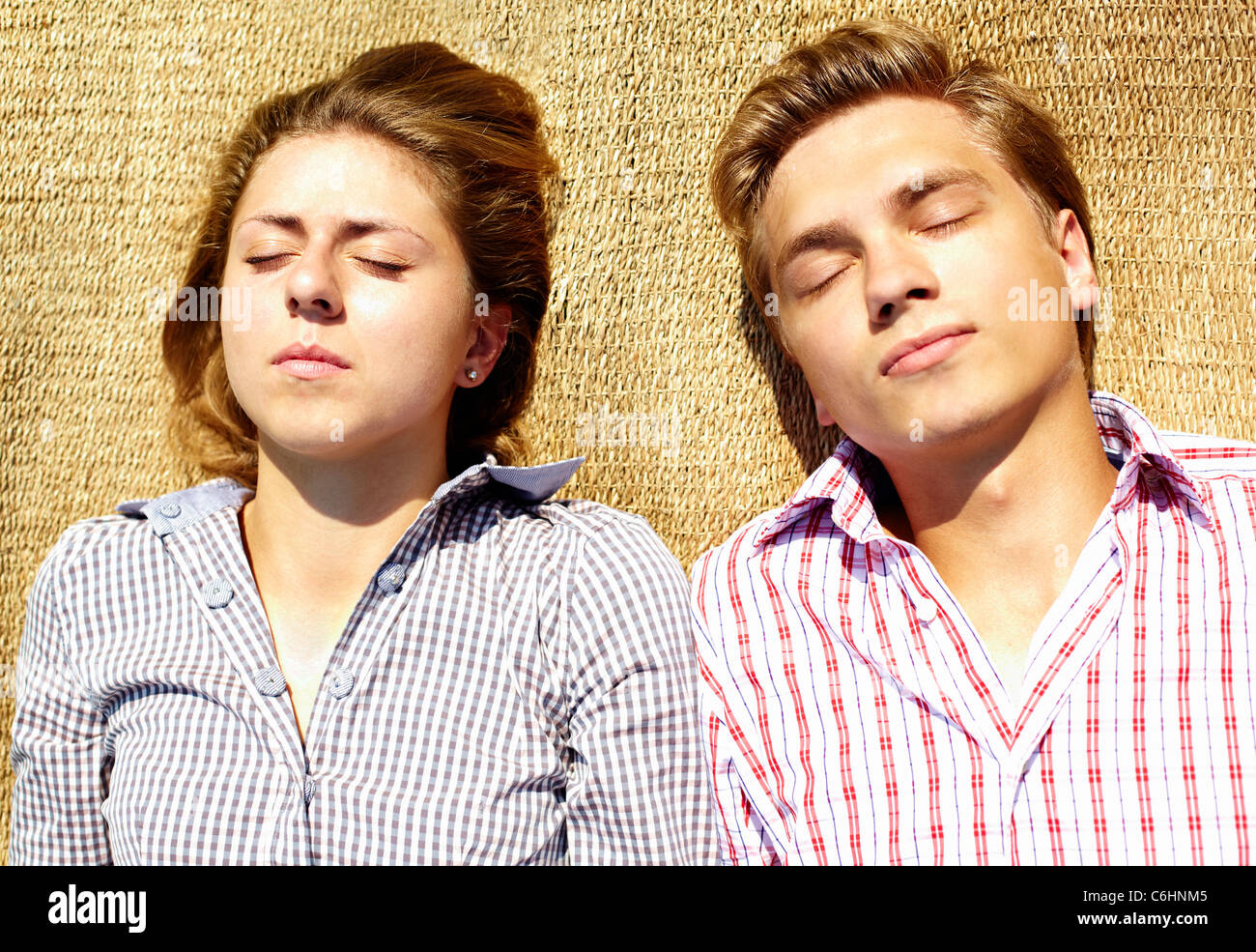 Portrait of young couple having a nap Stock Photo - Alamy