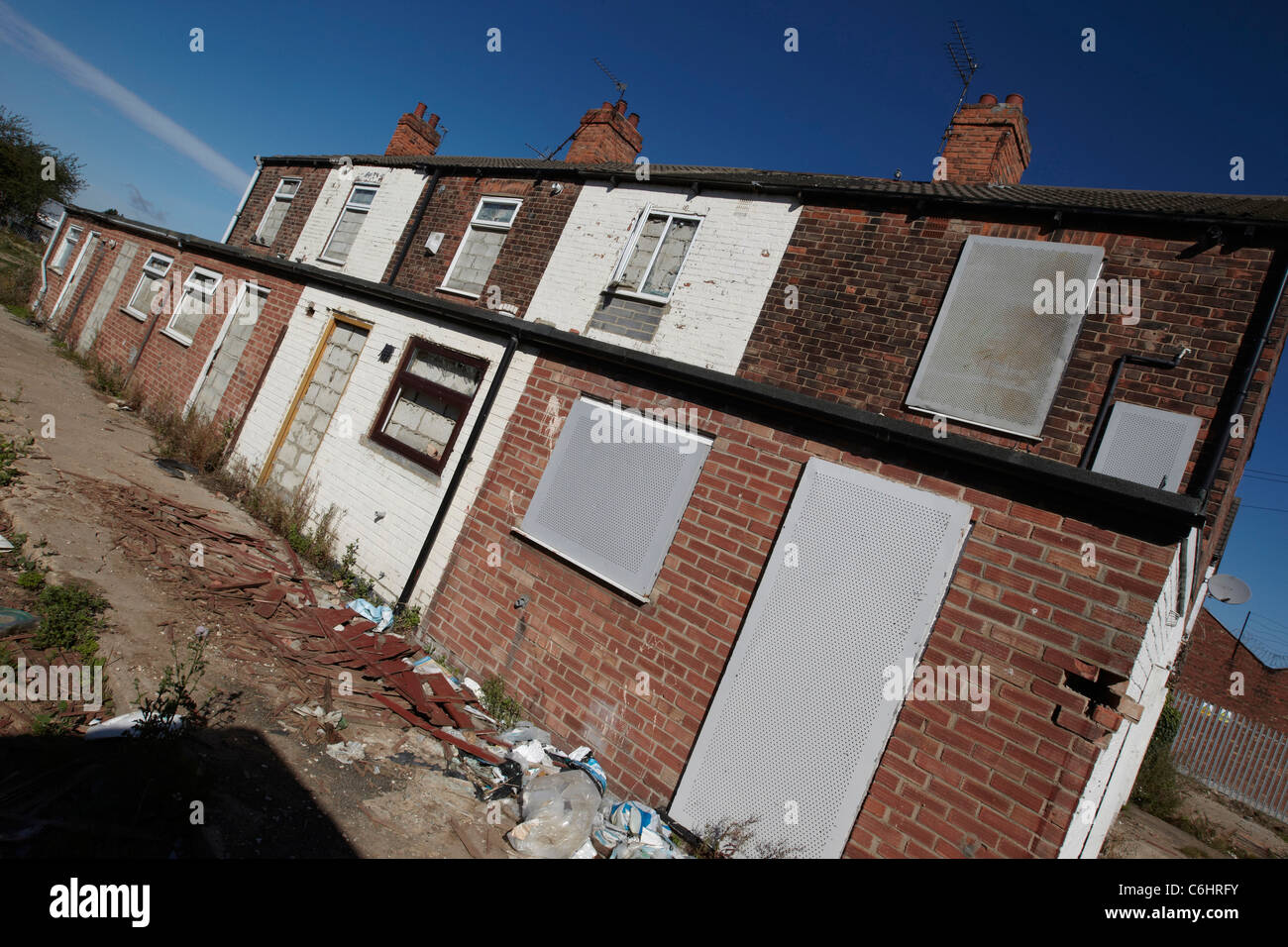 A row of empty abandoned derelict boarded up houses near Woodcock ...