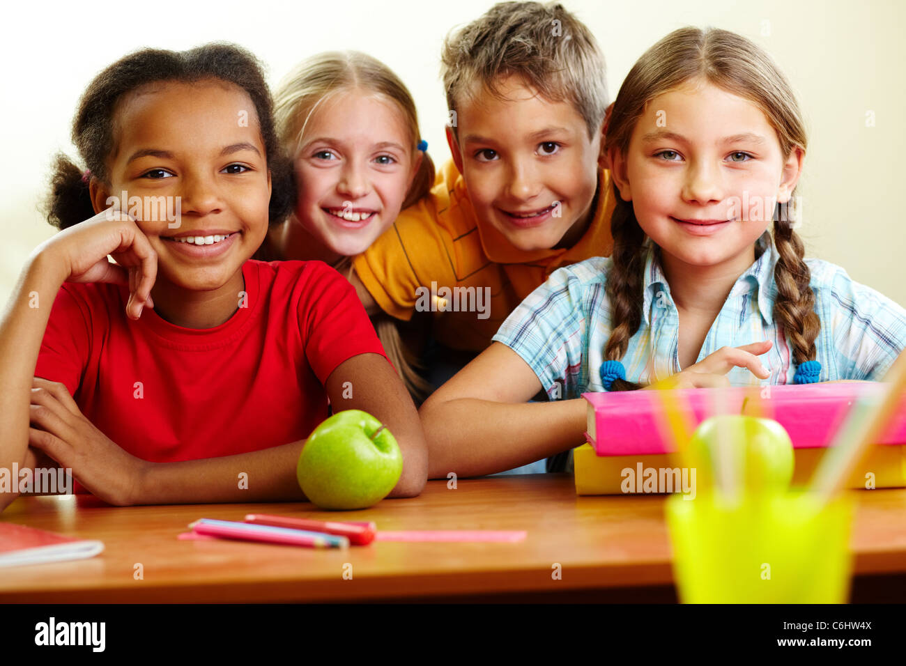 Portrait of smart schoolchildren looking at camera in classroom Stock ...