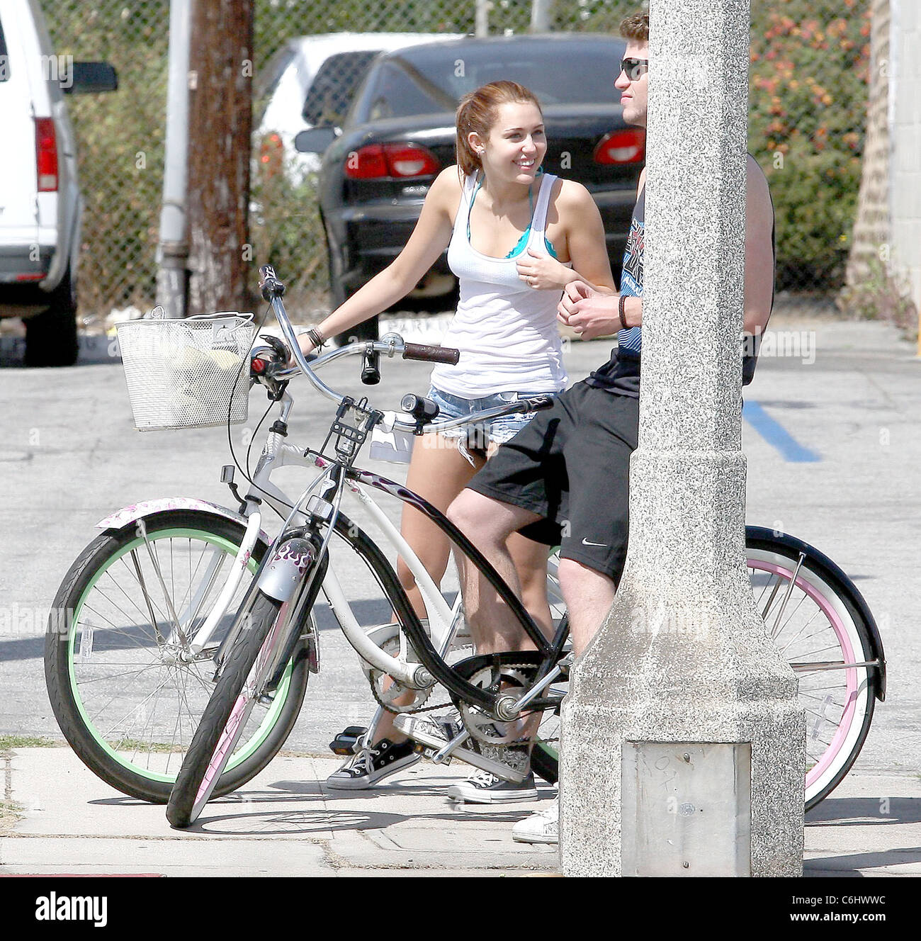 Miley Cyrus and Liam Hemsworth Miley Cyrus rides her bicycle with her ...