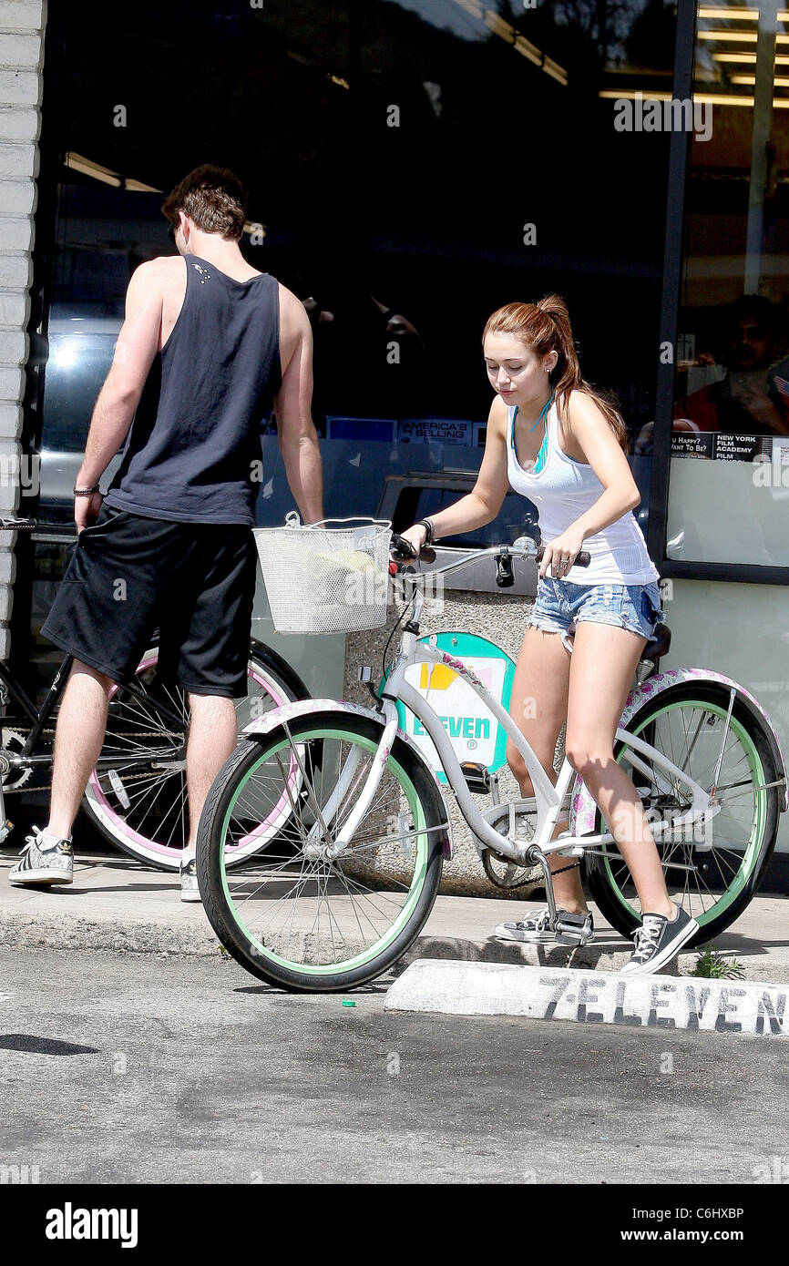 Miley cyrus rides bicycle boyfriend hi-res stock photography and images ...