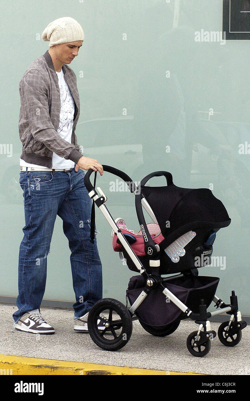 Spanish footballer Fernando Torres pushing his daughter Nora in a ...