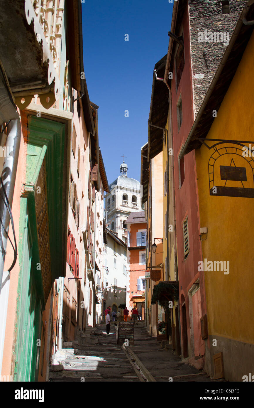 Brightly coloured buildings on a narrow street in the historic old city ...