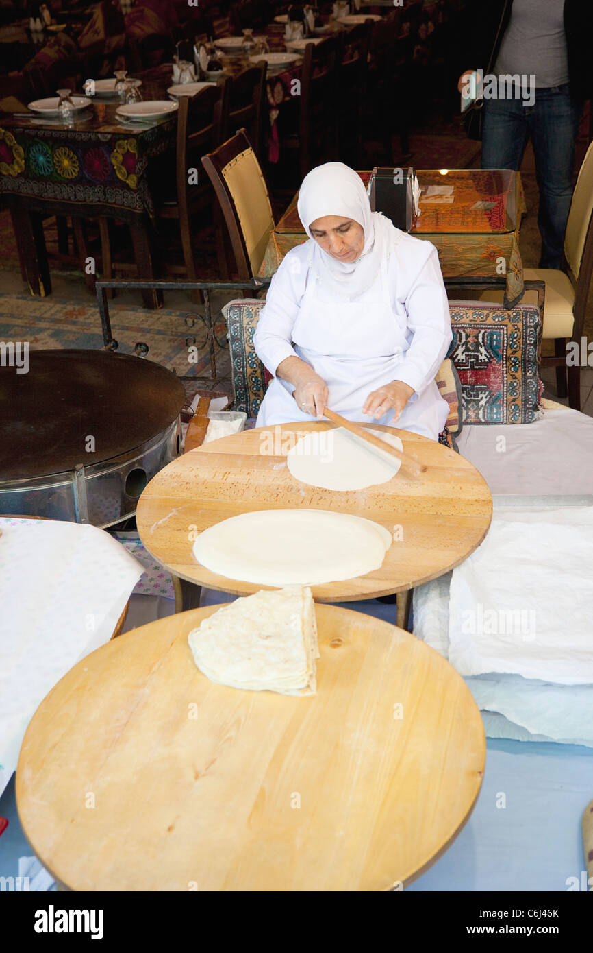 Turkey, Istanbul, Sultanahmet, woman rolling out bread dough in ...