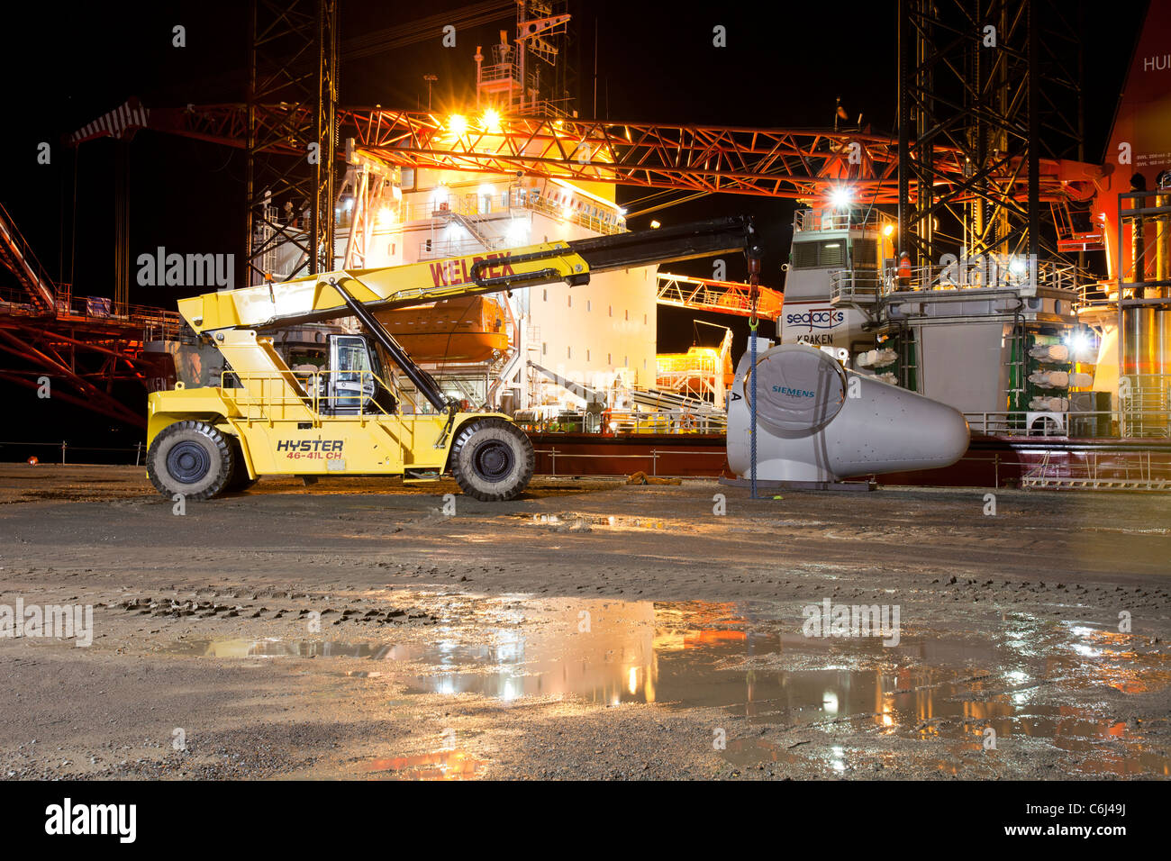 A jack up barge at Mostyn port and wind turbine parts Stock Photo - Alamy