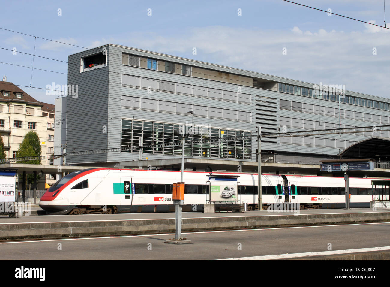 Sleek modern electric passenger train entering Luzern station ...