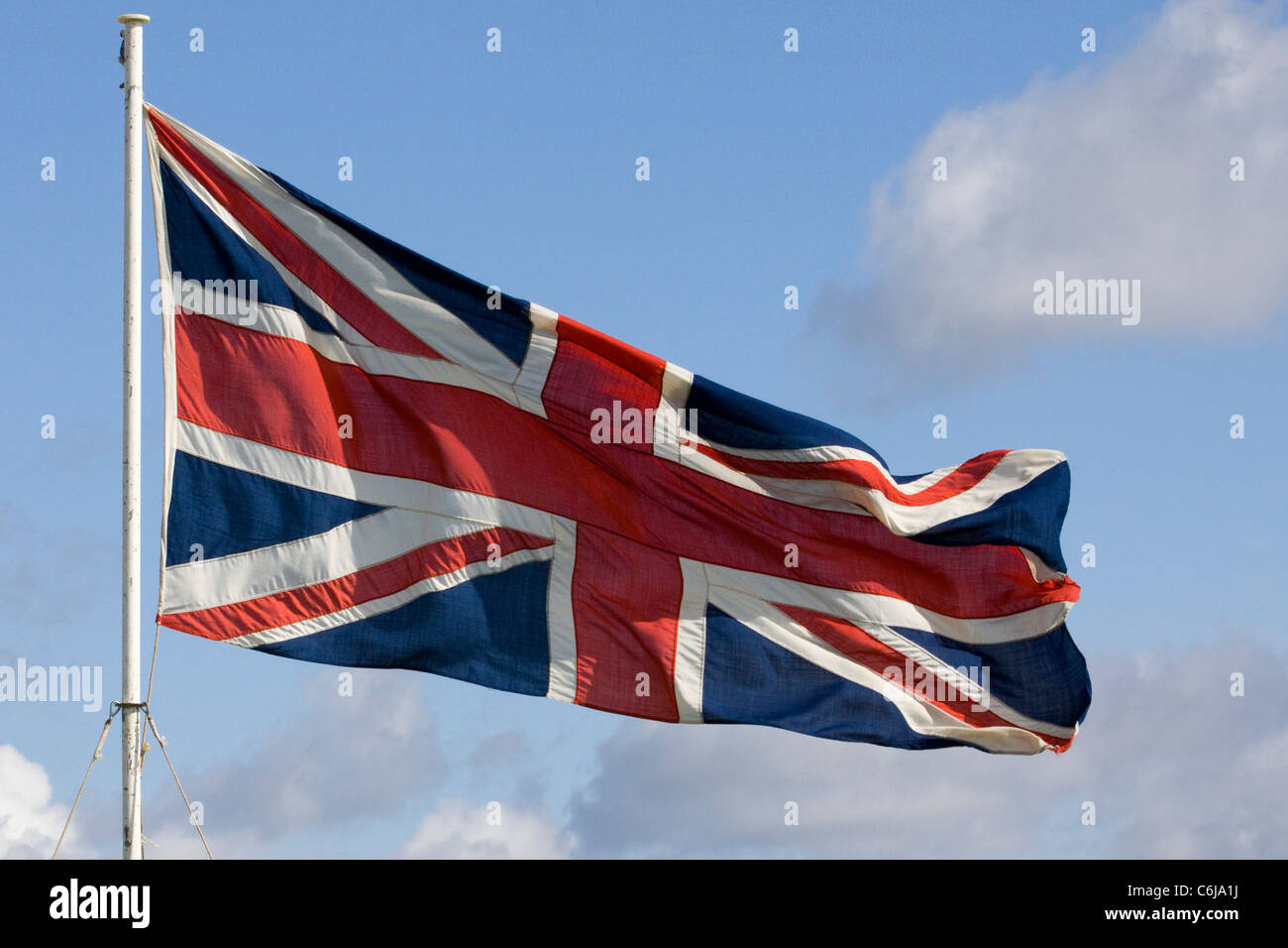 The Union Jack Flying against a blue sky Stock Photo - Alamy