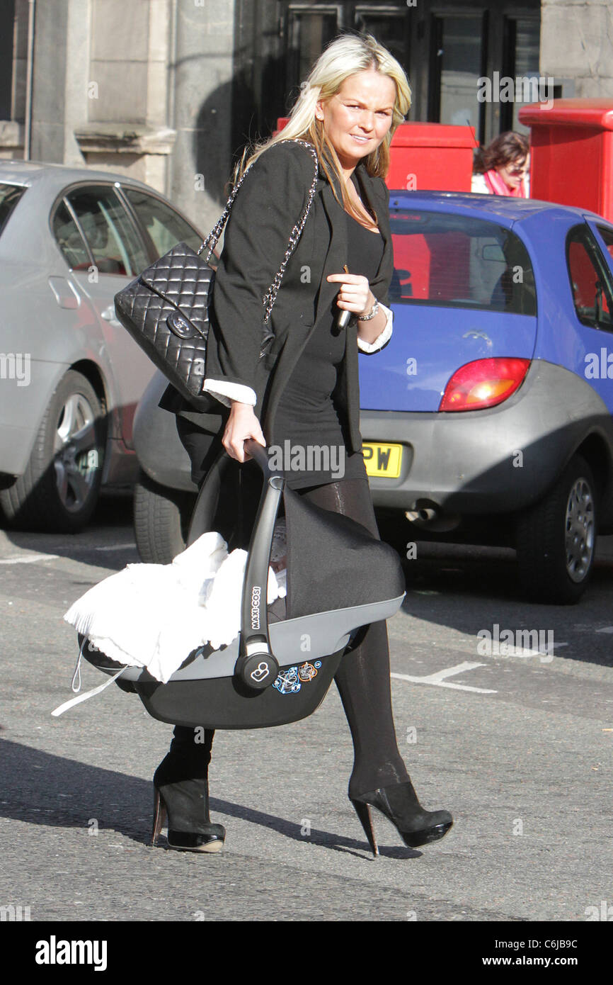 Jennifer Ellison carrying her son Bobby in a baby carrier while out and ...
