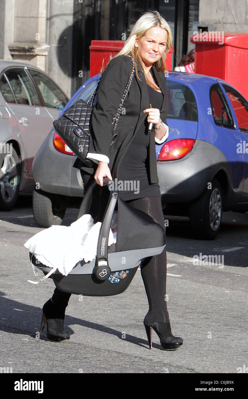 Jennifer Ellison carrying her son Bobby in a baby carrier while out and ...