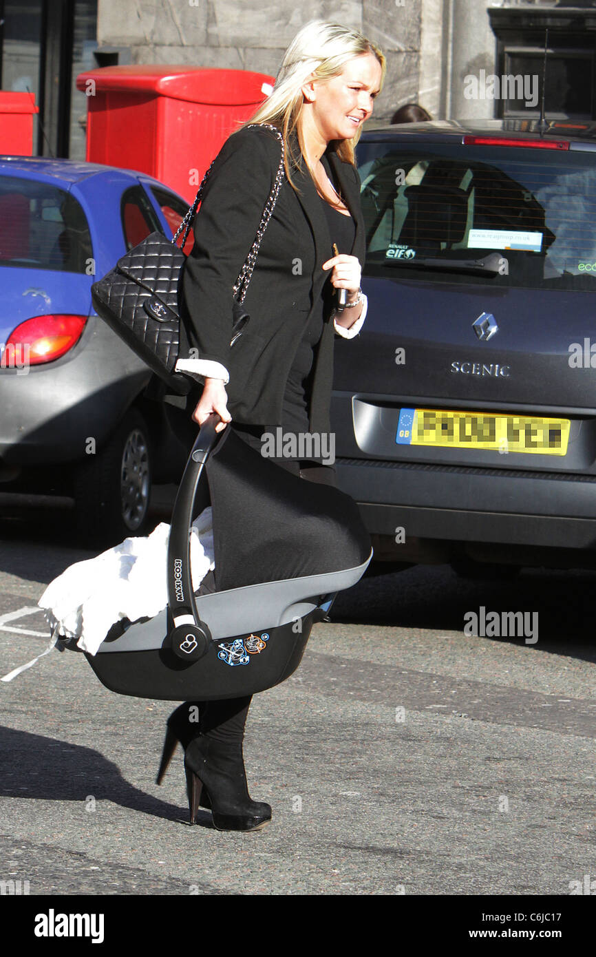 Jennifer Ellison carrying her son Bobby in a baby carrier while out and ...