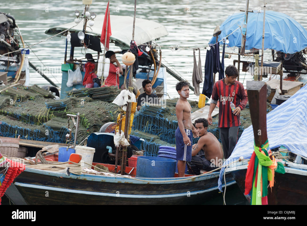 Burmese fishermen on colorful boats at Thetsaban Na Thon port, Ko Samui ...