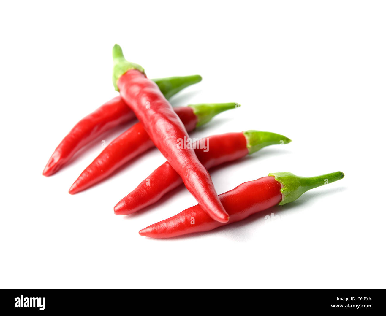 Five chili peppers sorted on a white background Stock Photo - Alamy