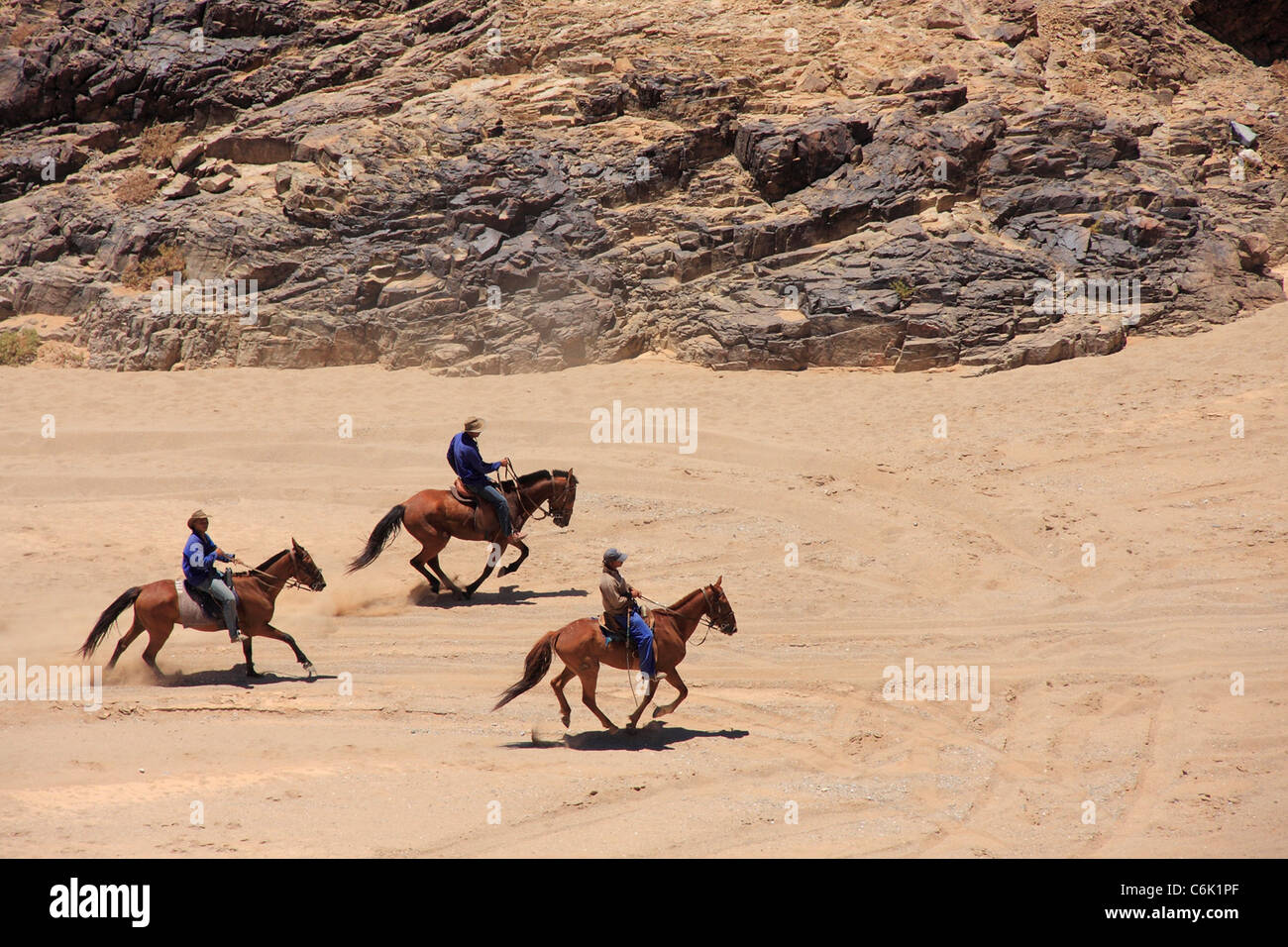 Horse riders in desert landscape Stock Photo - Alamy