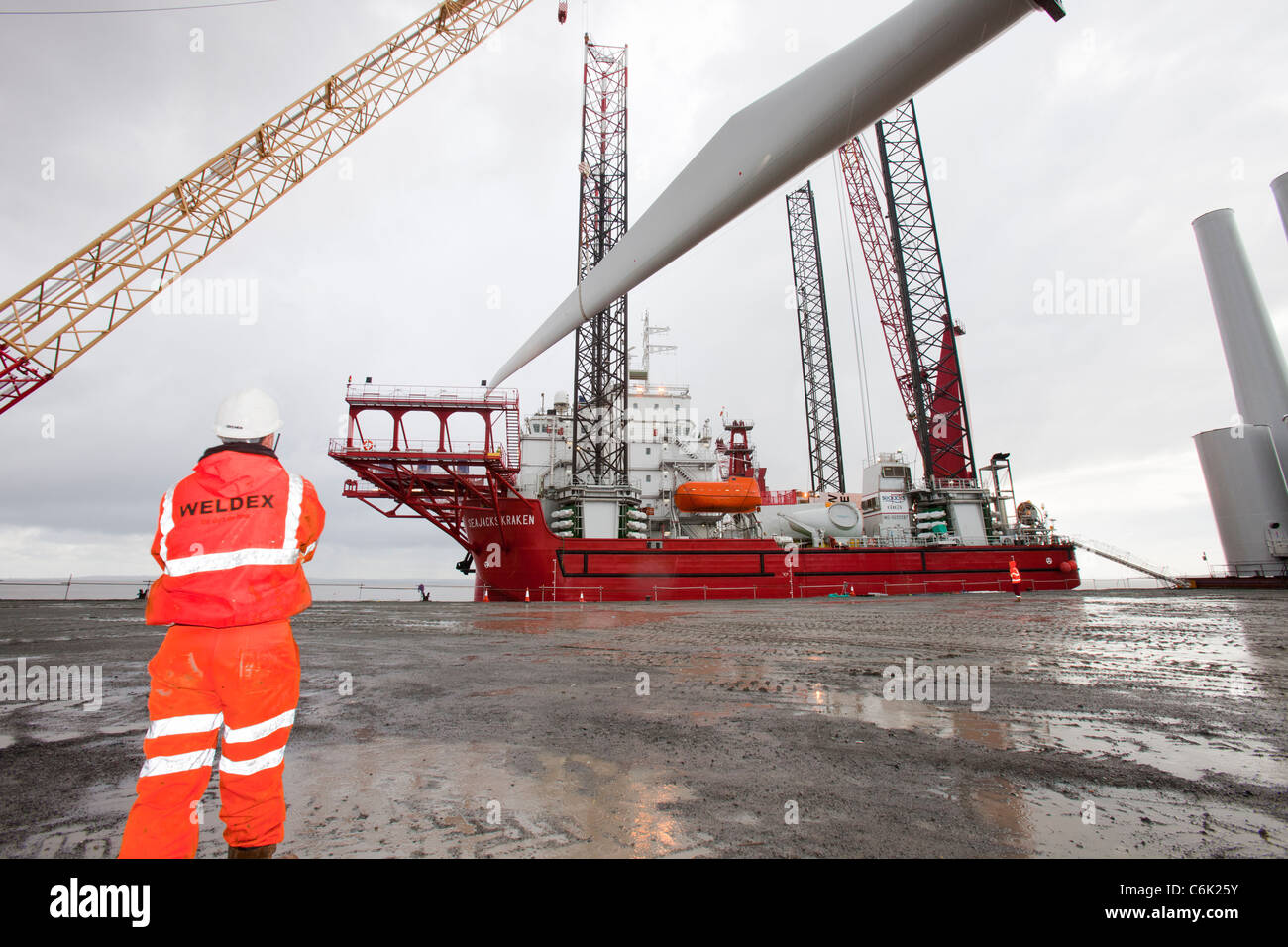A jack up barge at Mostyn port and wind turbine parts Stock Photo - Alamy