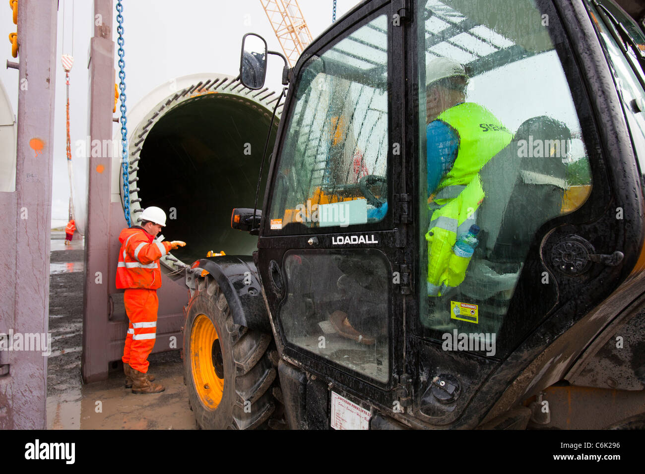 workmen moving wind turbine blades at Mostyn port, Wales Stock Photo ...