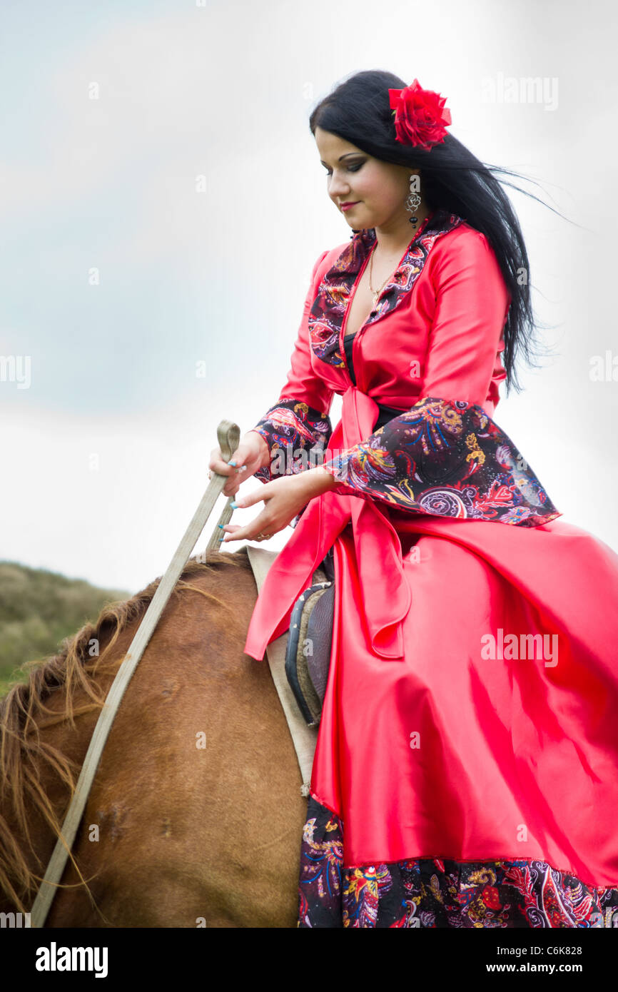 Beautiful gypsy girl riding a horse Stock Photo - Alamy
