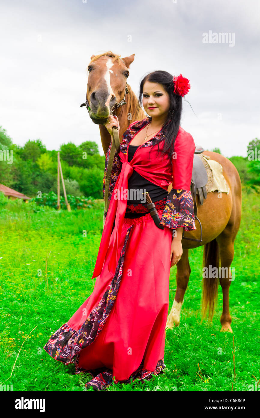 Beautiful gypsy girl riding a horse Stock Photo - Alamy