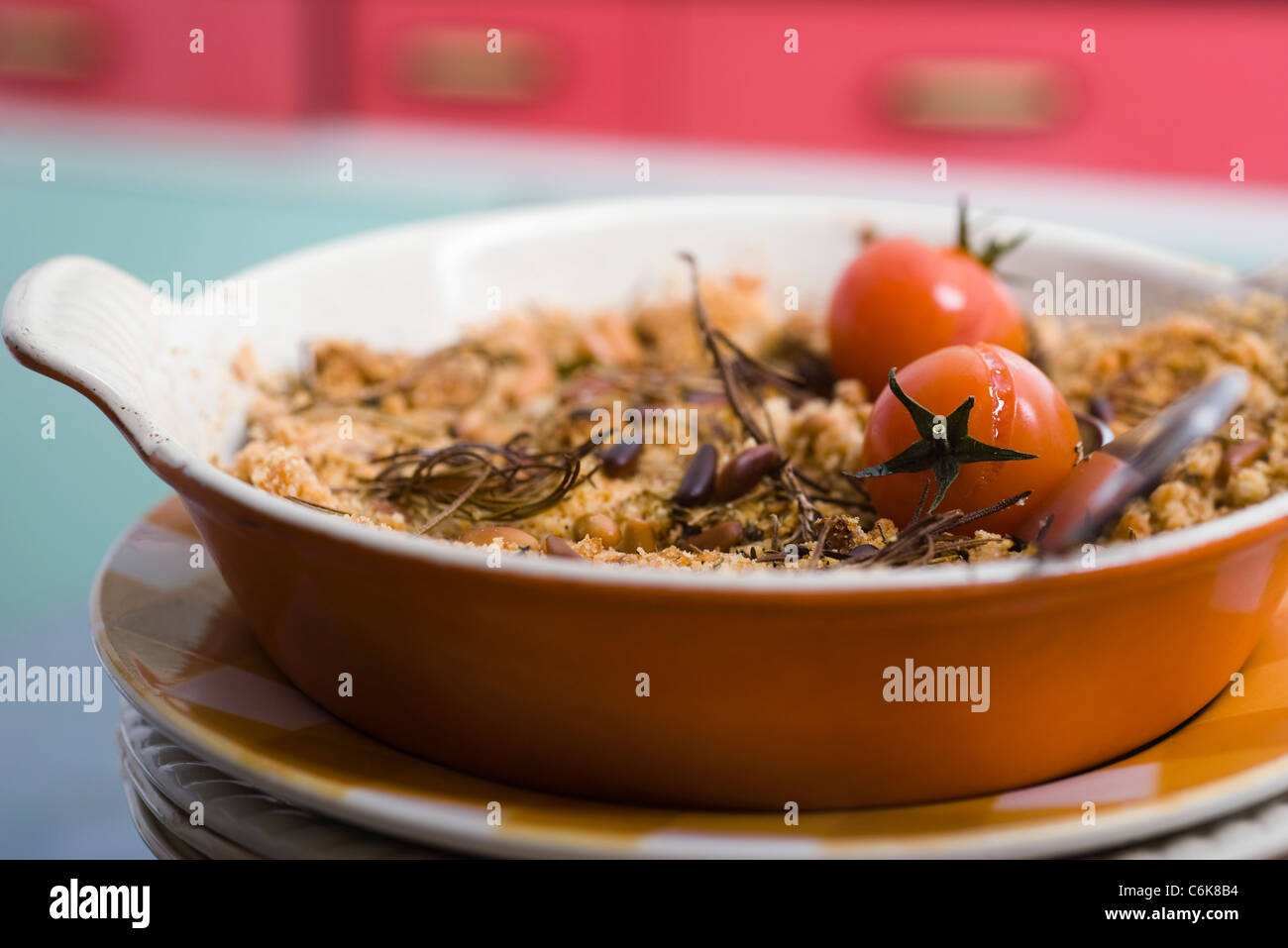 Tomato and herb crumble in baking dish Stock Photo - Alamy