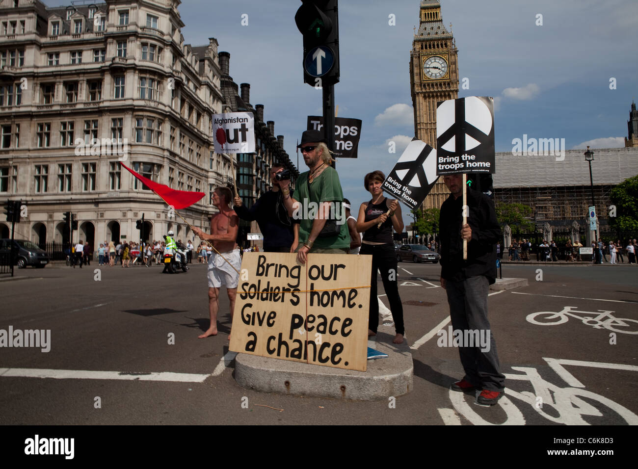 Activists from Democracy Village display banners for peace as the Queen ...
