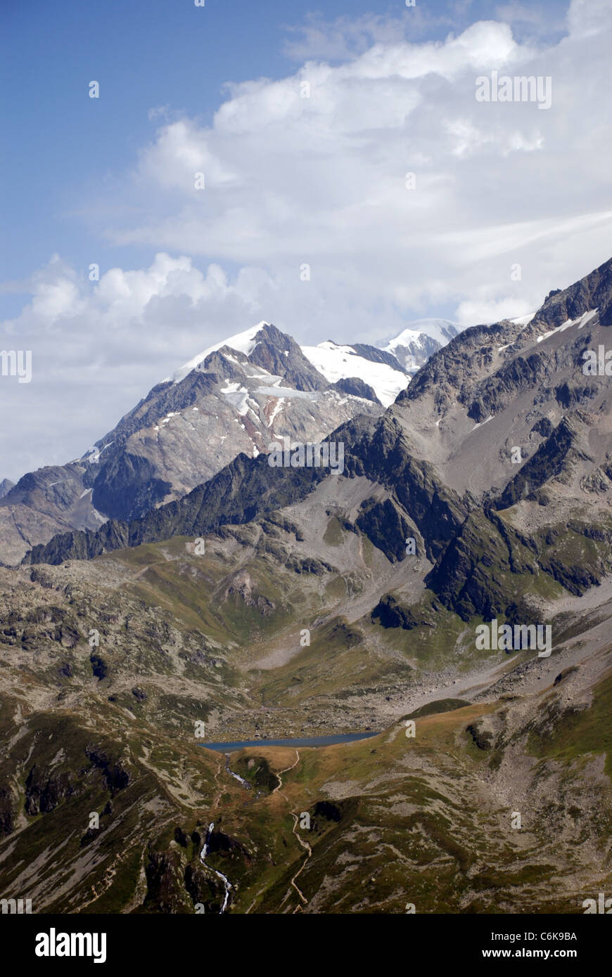 the snow capped summit of Mont Blanc rises behind the other mountains ...
