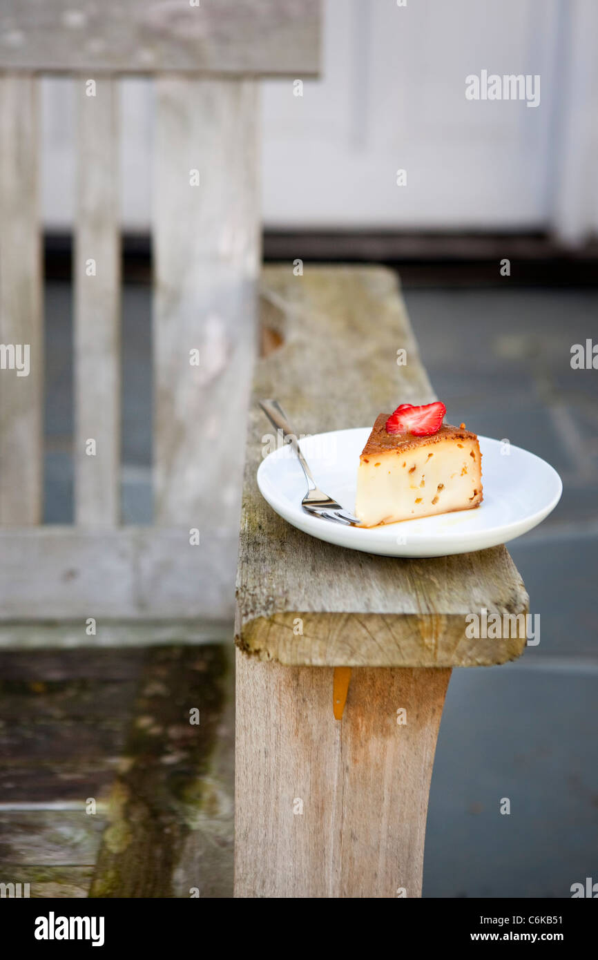 Slice of desert with strawberries on patio Stock Photo - Alamy