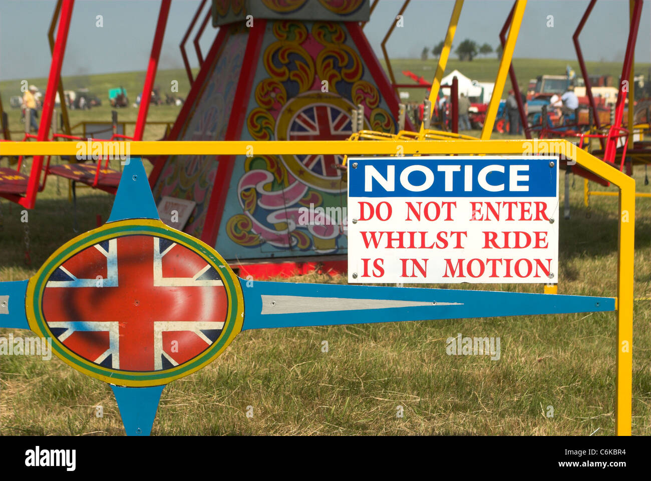 Funfair ride warning at a summer rally in West Sussex Stock Photo - Alamy