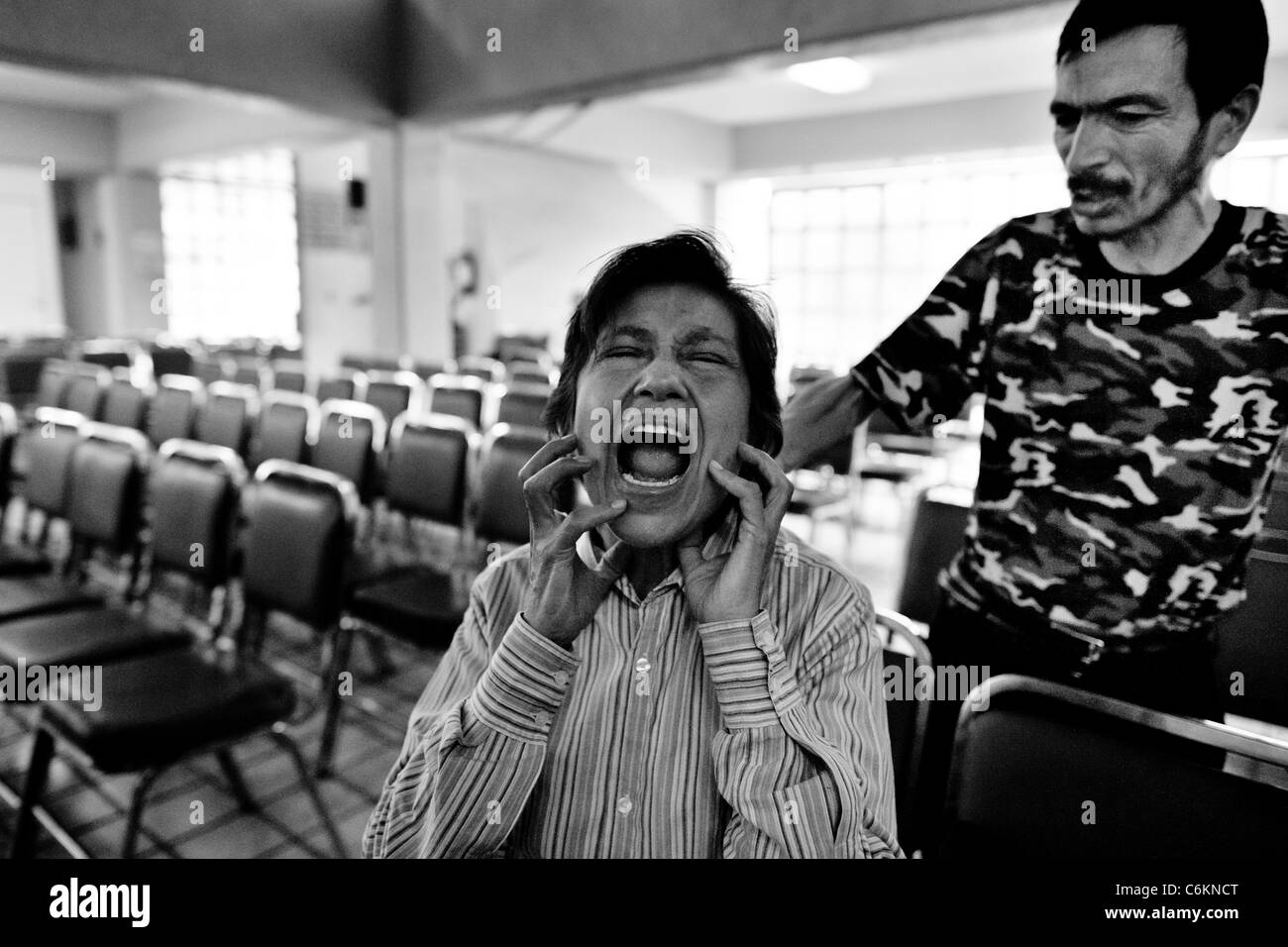 A Mexican woman screams intensively during the exorcism rite performed ...