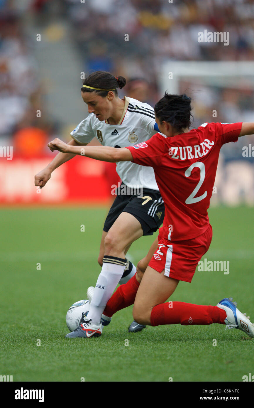 BERLIN - JUNE 26: Emily Zurrer of Canada (R) tries to tackle the ball ...