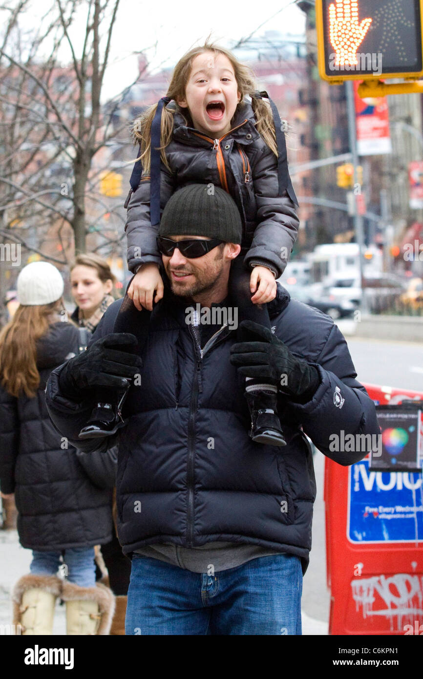 Hugh Jackman carries his daughter Ava Eliot Jackman while walking ...