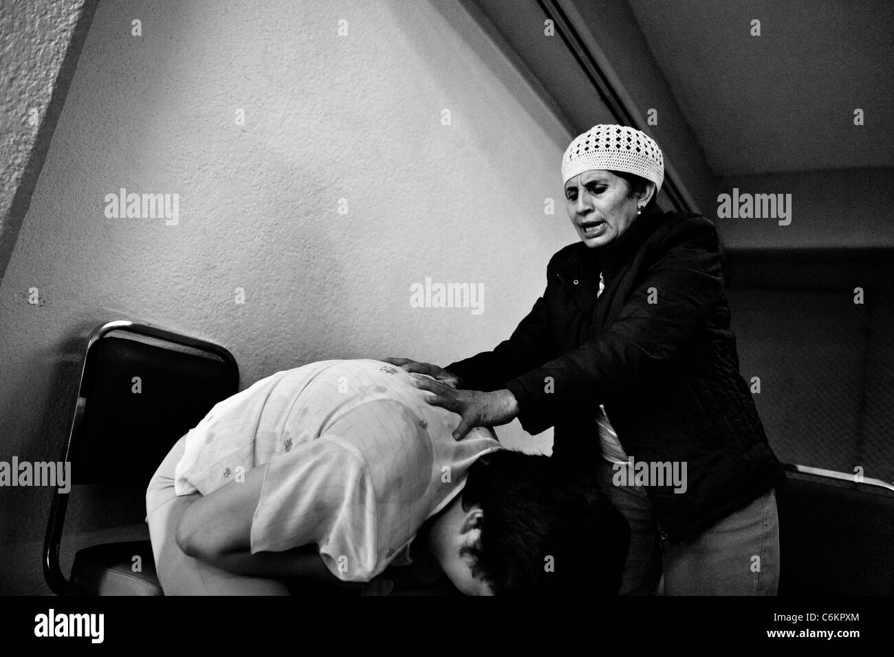 A Mexican woman womits during the exorcism ritual performed at the ...