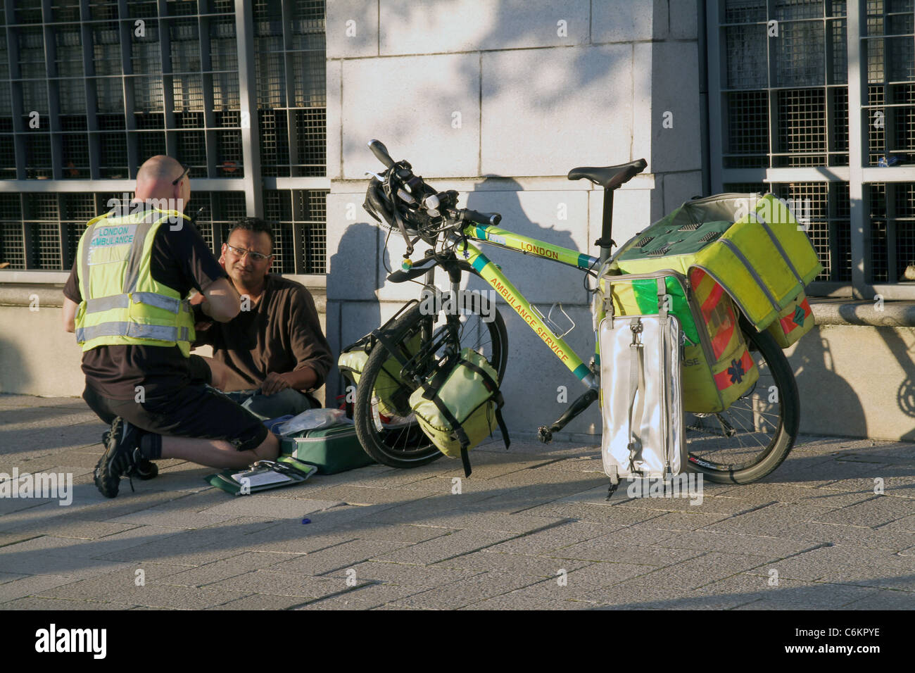 Paramedic on bicycle ambulance attends a patient on a London street, UK ...
