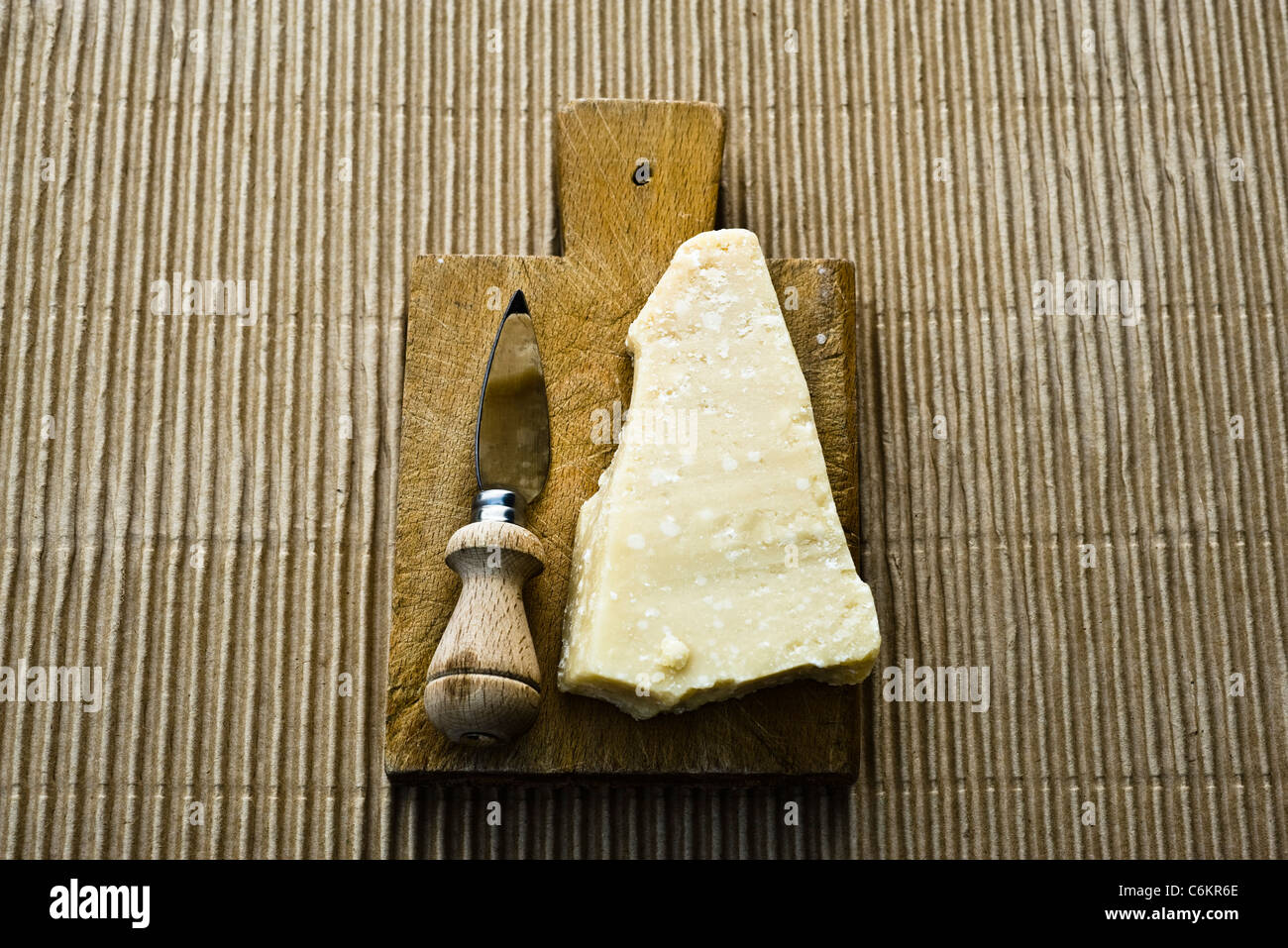 Parmesan cheese and knife on cutting board Stock Photo - Alamy