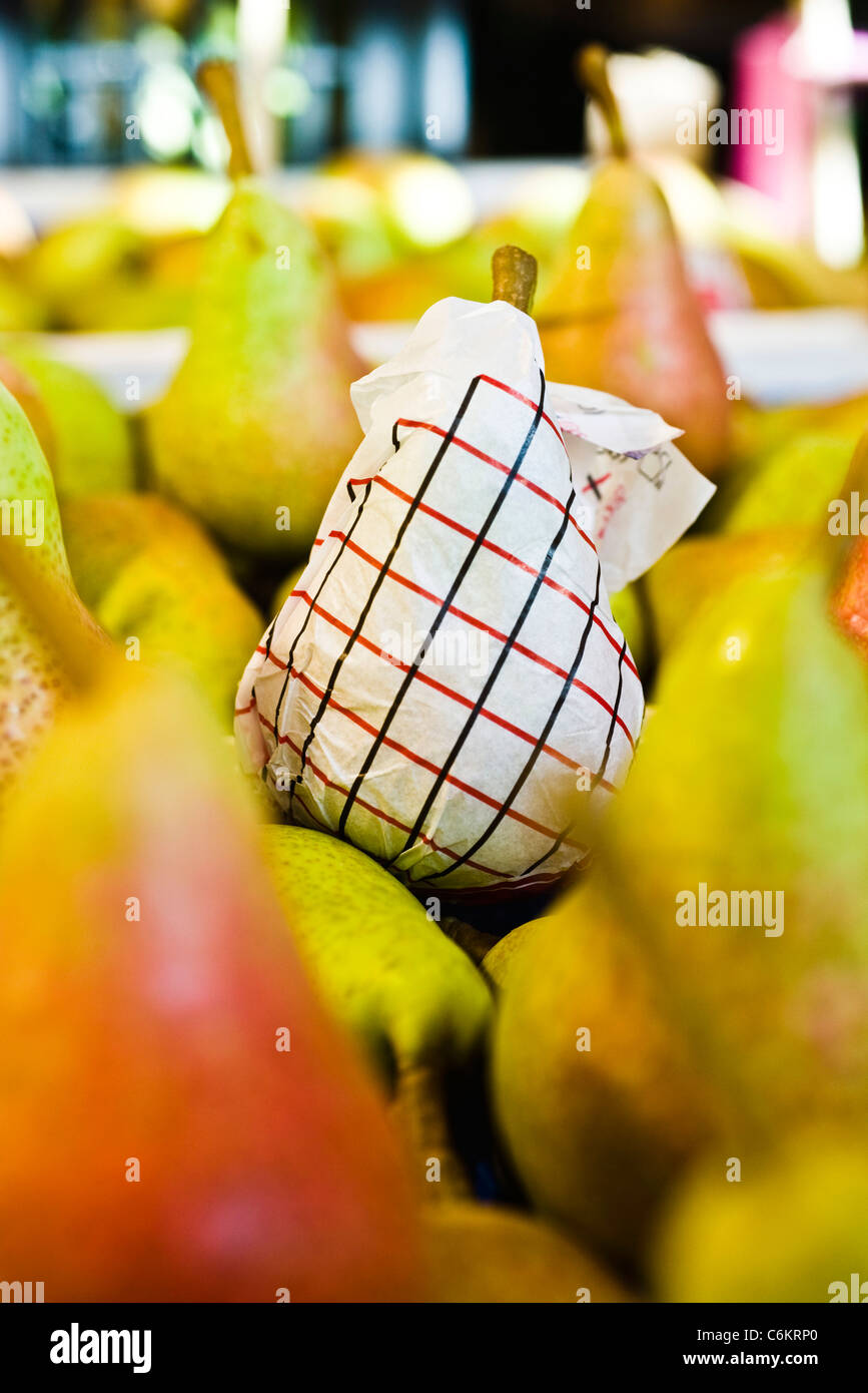 Fresh ripe pears, one wrapped in tissue paper Stock Photo - Alamy