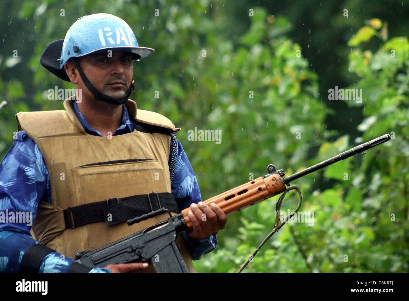India's Rapid Action Force (RAF) personnel hold weapons during a patrol ...
