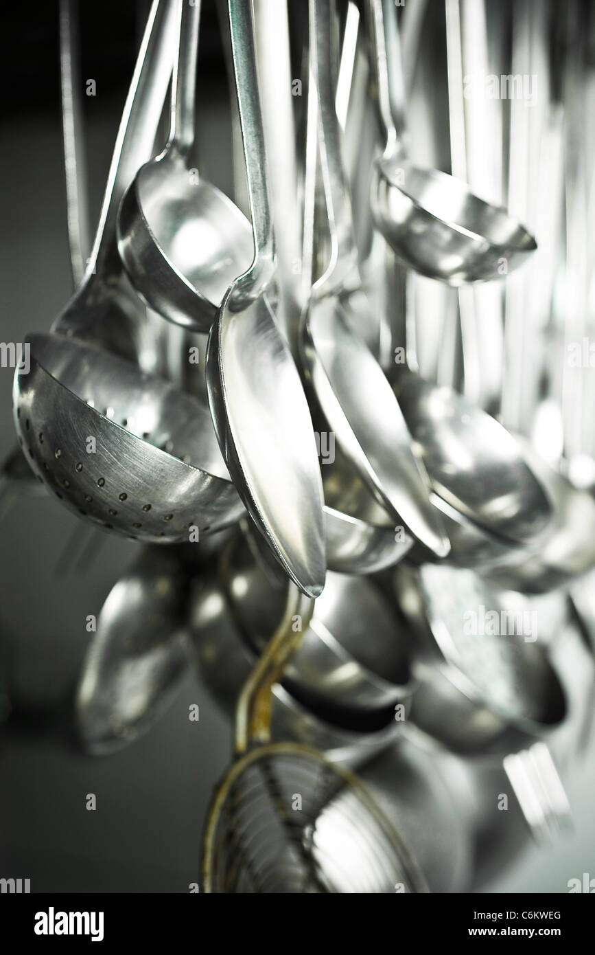 Cooking utensils hanging in kitchen Stock Photo - Alamy