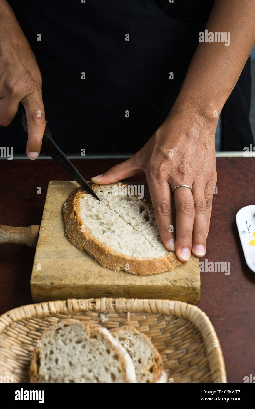 Cutting slice of bread in half Stock Photo - Alamy