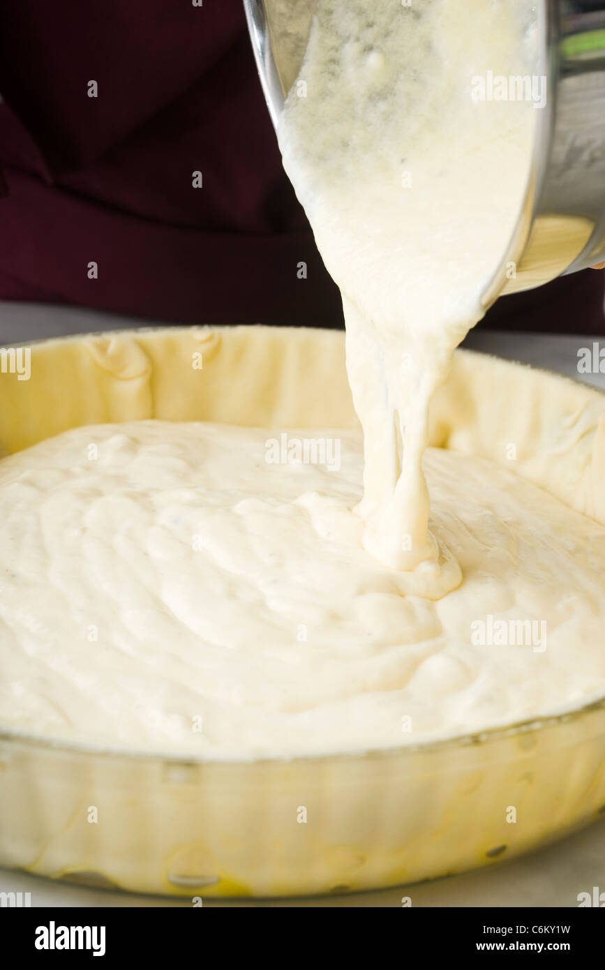 Quiche lorraine, pouring egg mixture into pastry crust Stock Photo - Alamy