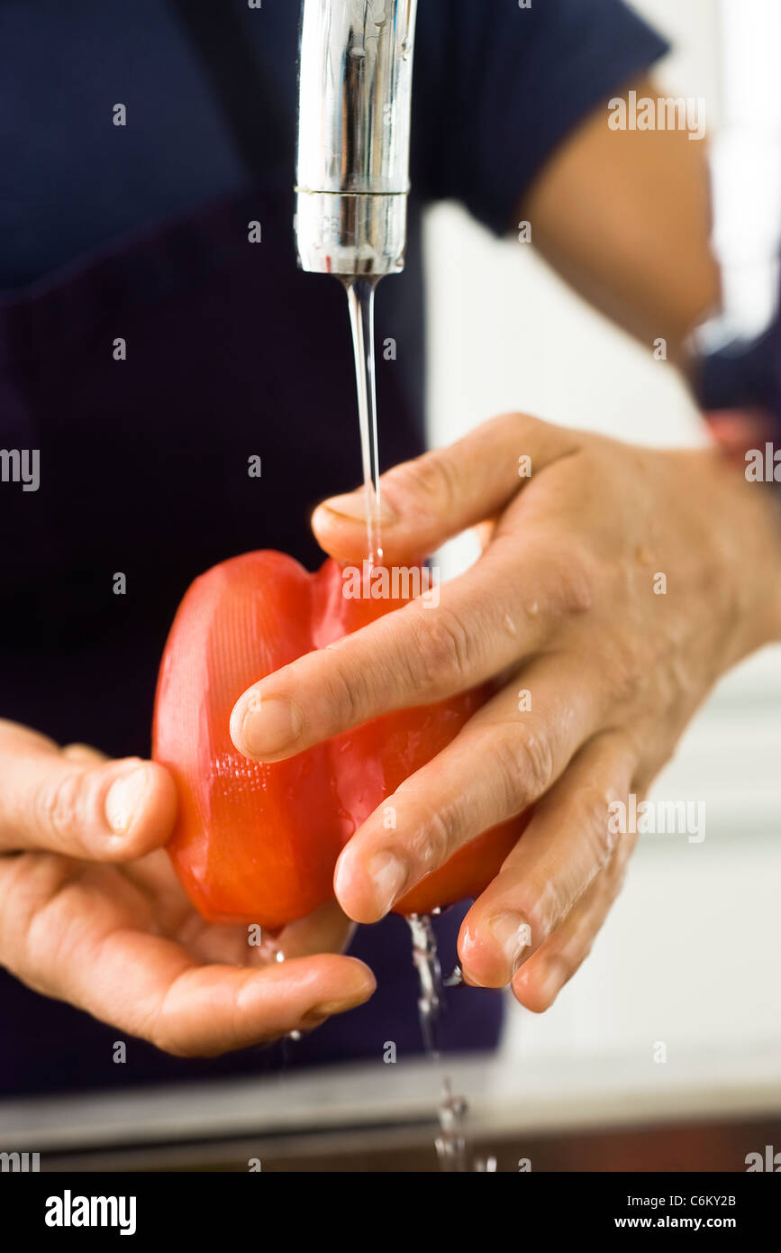 Washing red bell pepper Stock Photo - Alamy