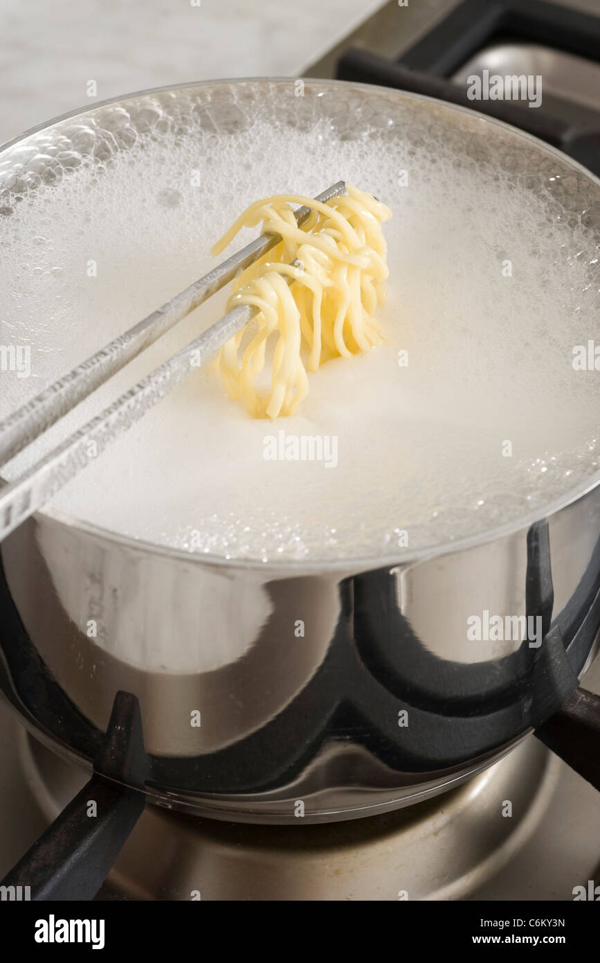 Boiling fresh homemade pasta Stock Photo - Alamy