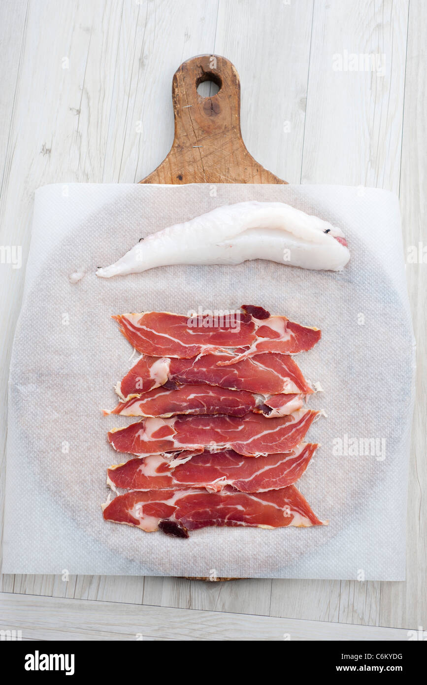 Fresh monkfish and sliced ham arranged on parchment Stock Photo - Alamy