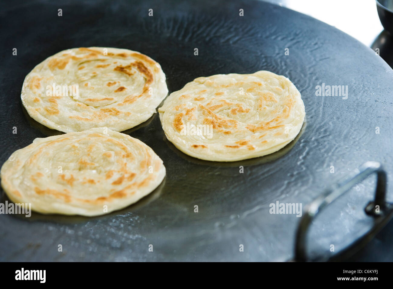 Thai sweet roti cooking on griddle Stock Photo - Alamy
