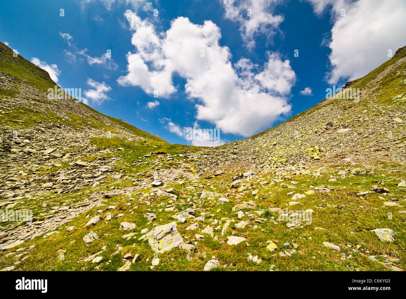 Landscape with a valley between mountains and blue sky with clouds ...