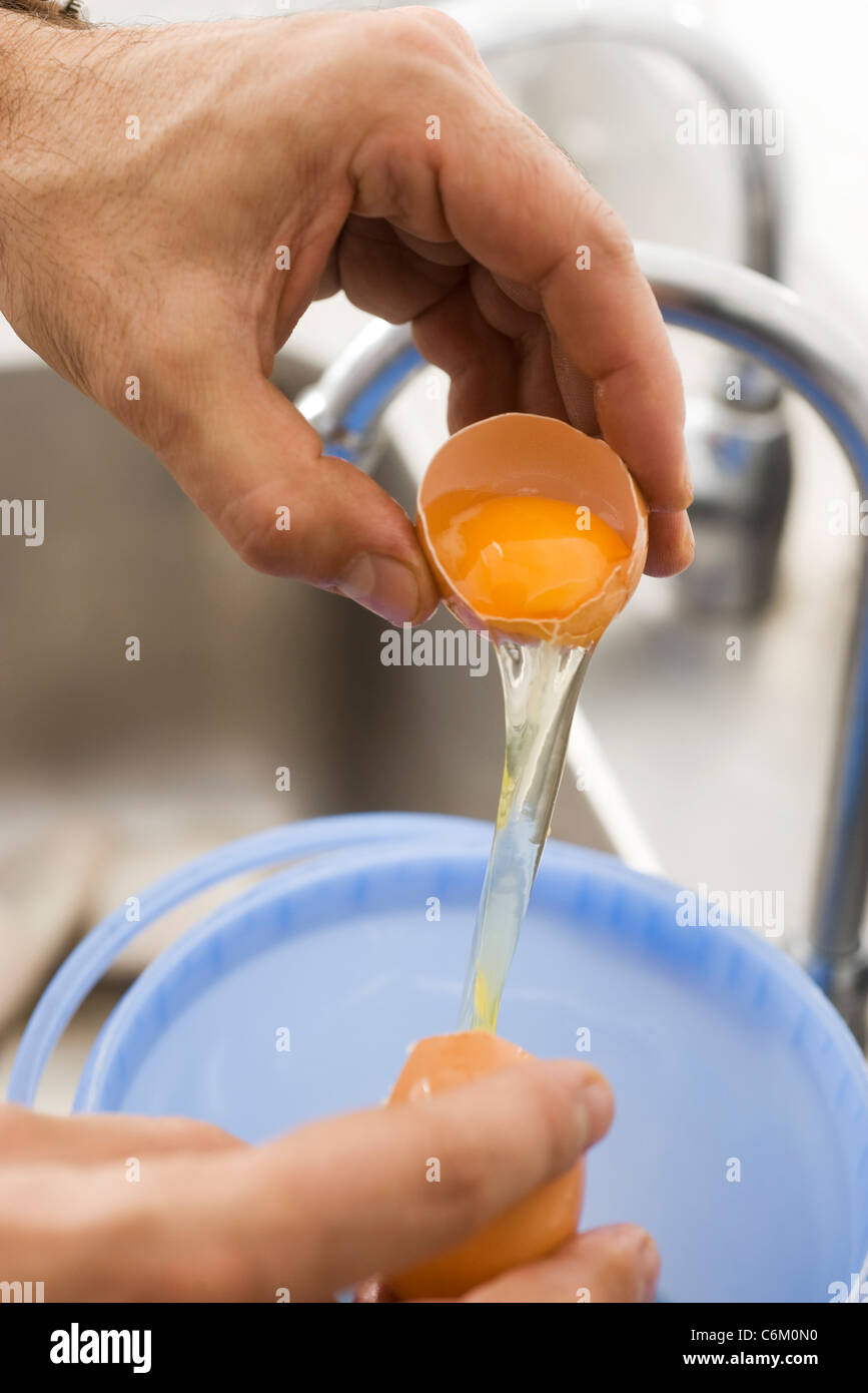 Separating egg white and yolk Stock Photo - Alamy