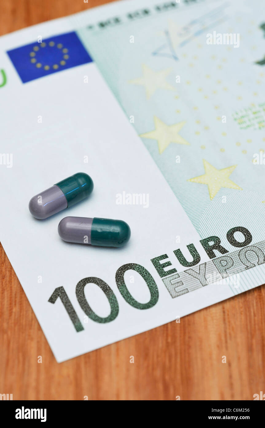 Capsules on 100 euro banknote Stock Photo - Alamy