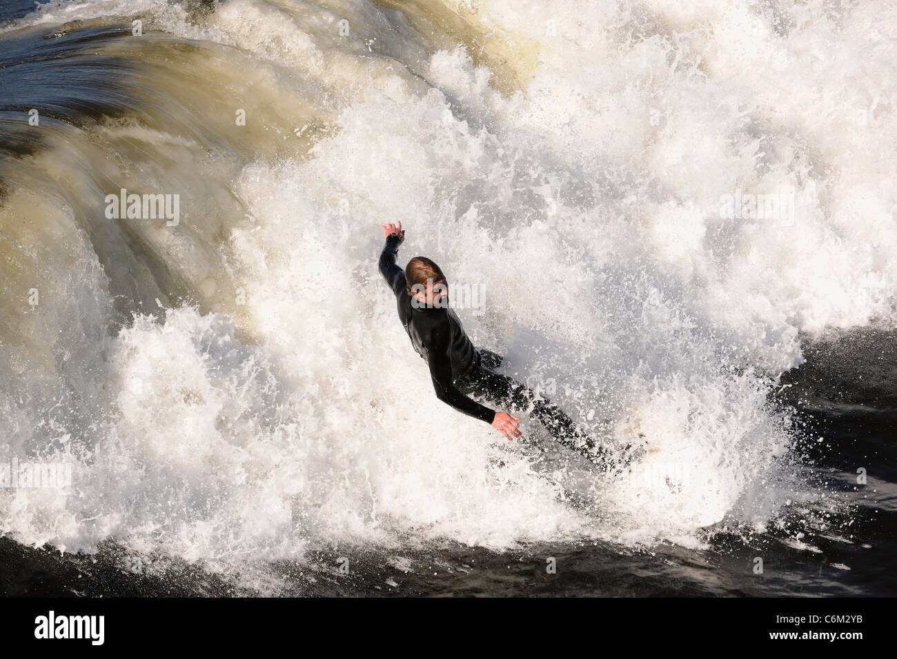 Surfer gets up on a wave. The wave twists with foam and splashes Stock ...